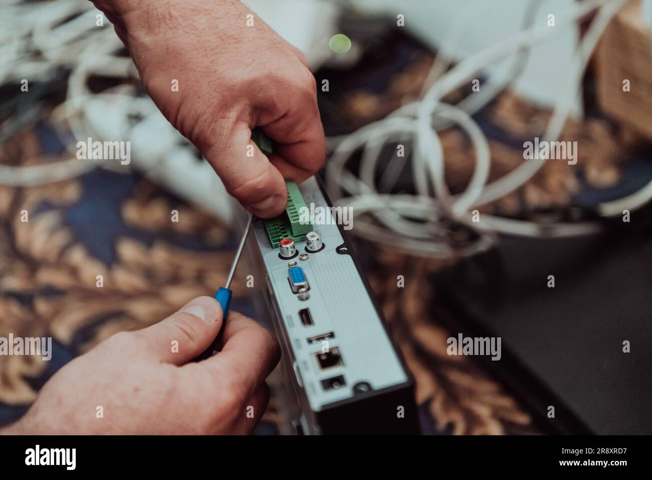 Repairing a technical device. A repairman repairs a broken device Stock ...