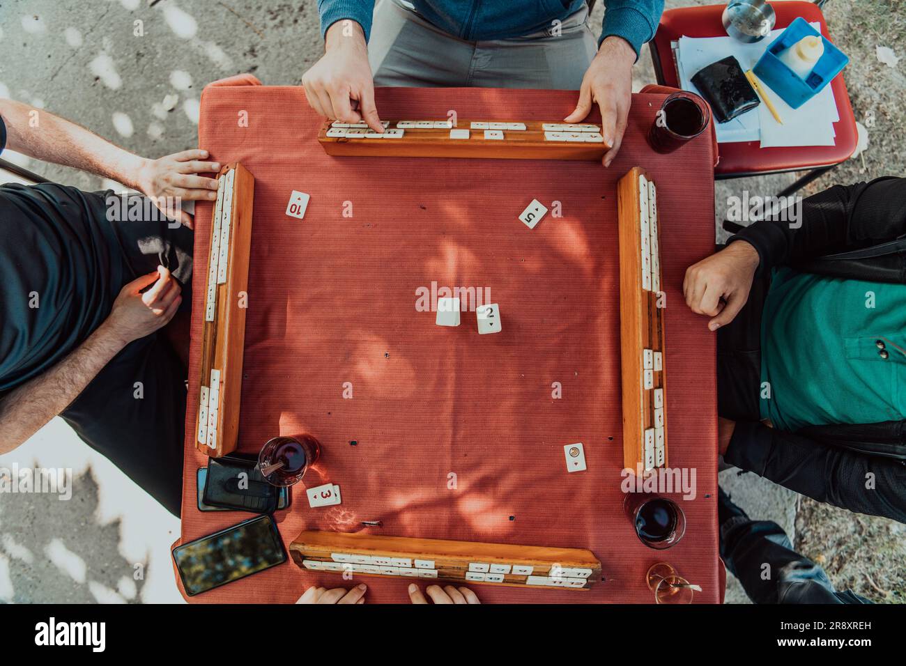 A group of men drink traditional Turkish tea and play a Turkish game ...