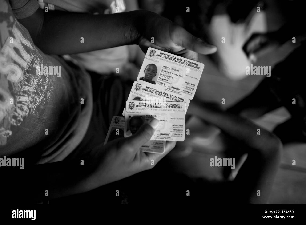 A Colombian refugee child displays his family's new refugee visas in ...