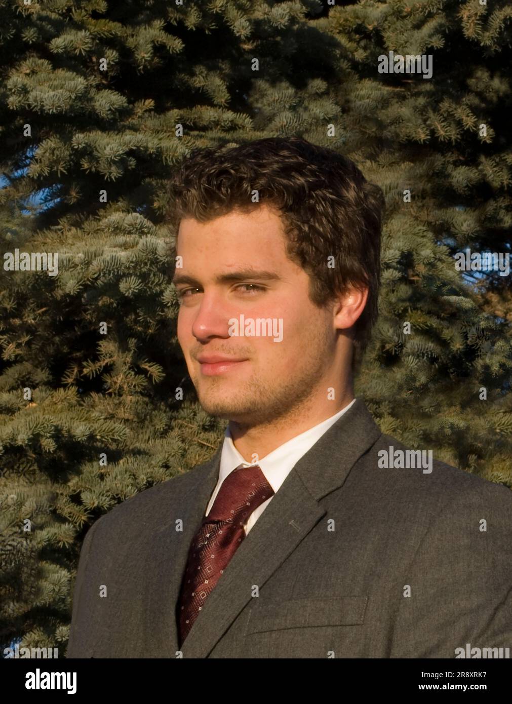 Levi Johnston poses for a portrait in front of a stand of evergreen ...