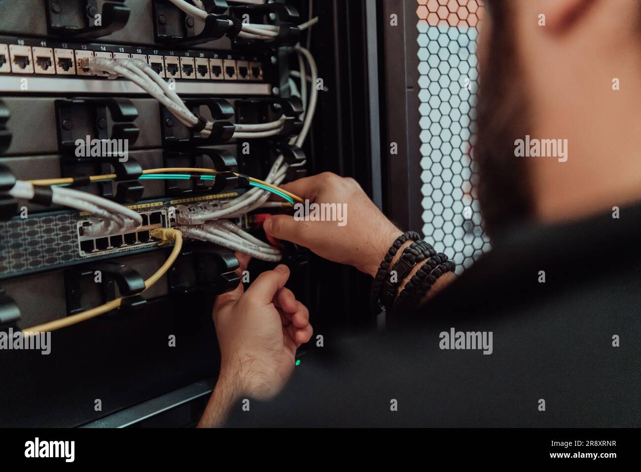 Close up of technician setting up network in server room Stock Photo - Alamy