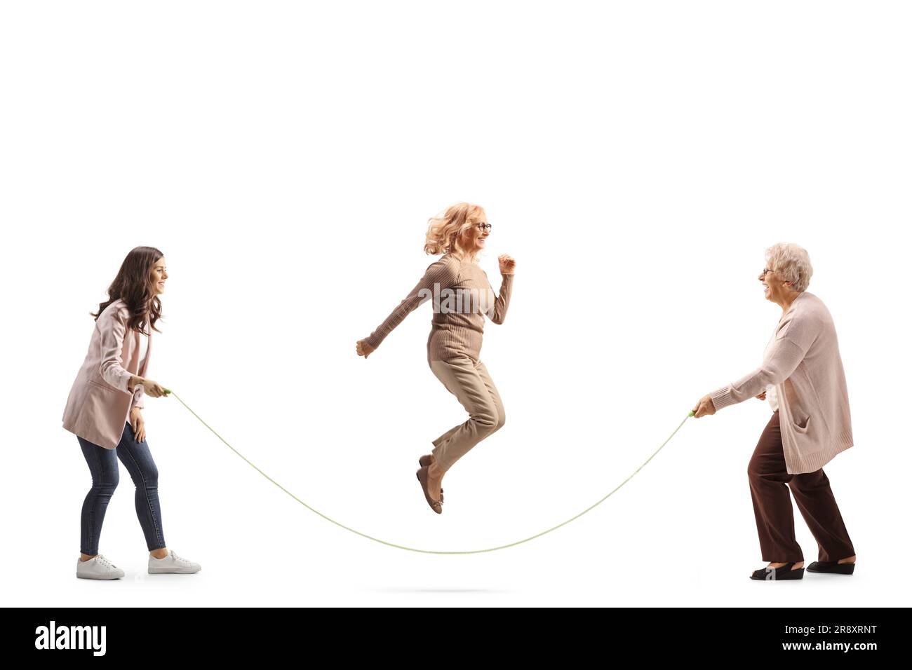 Young and older women playing skipping rope isolated on white ...