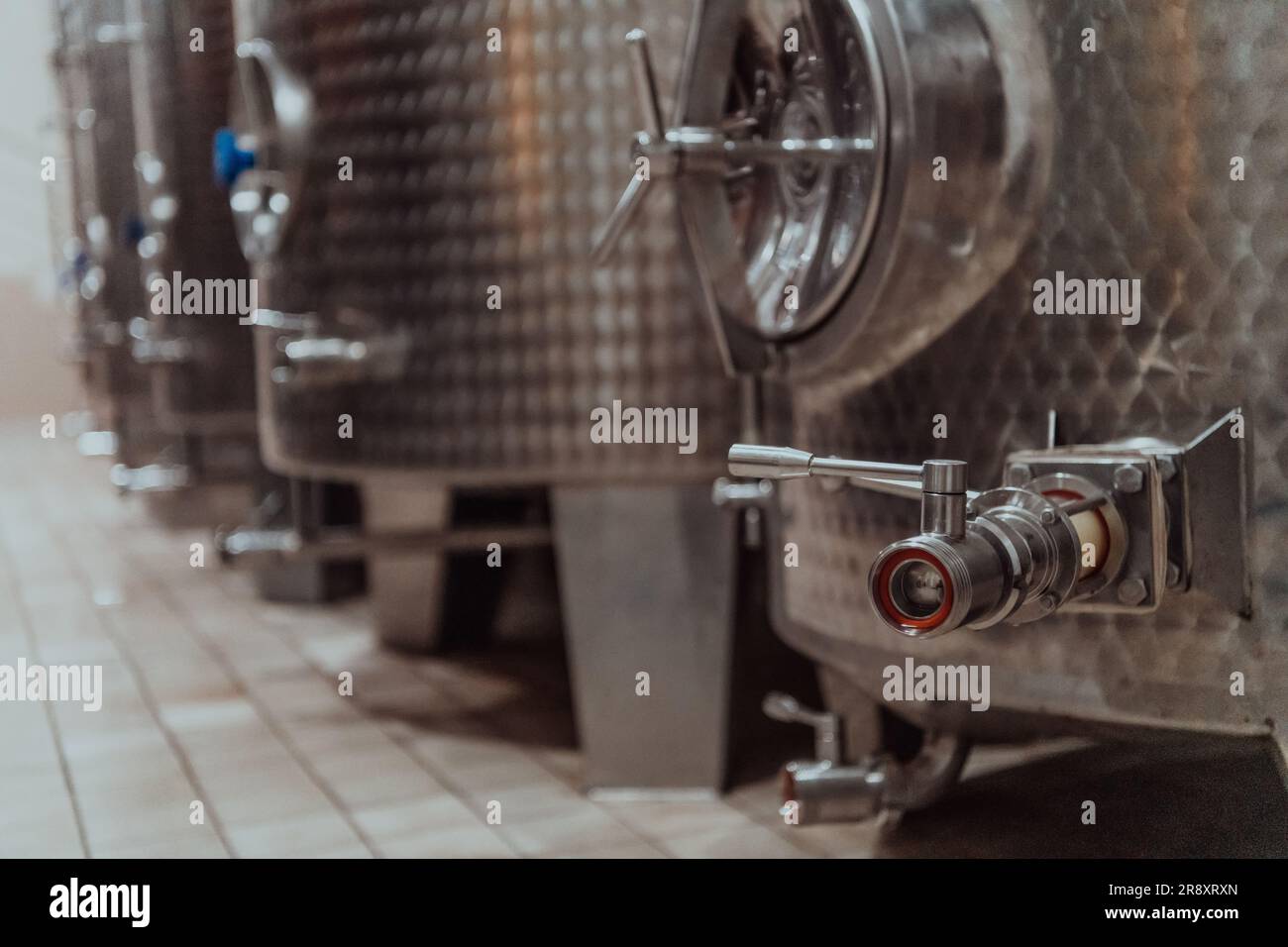 Modern wine distillery and brewery with brew kettles pipes and ...