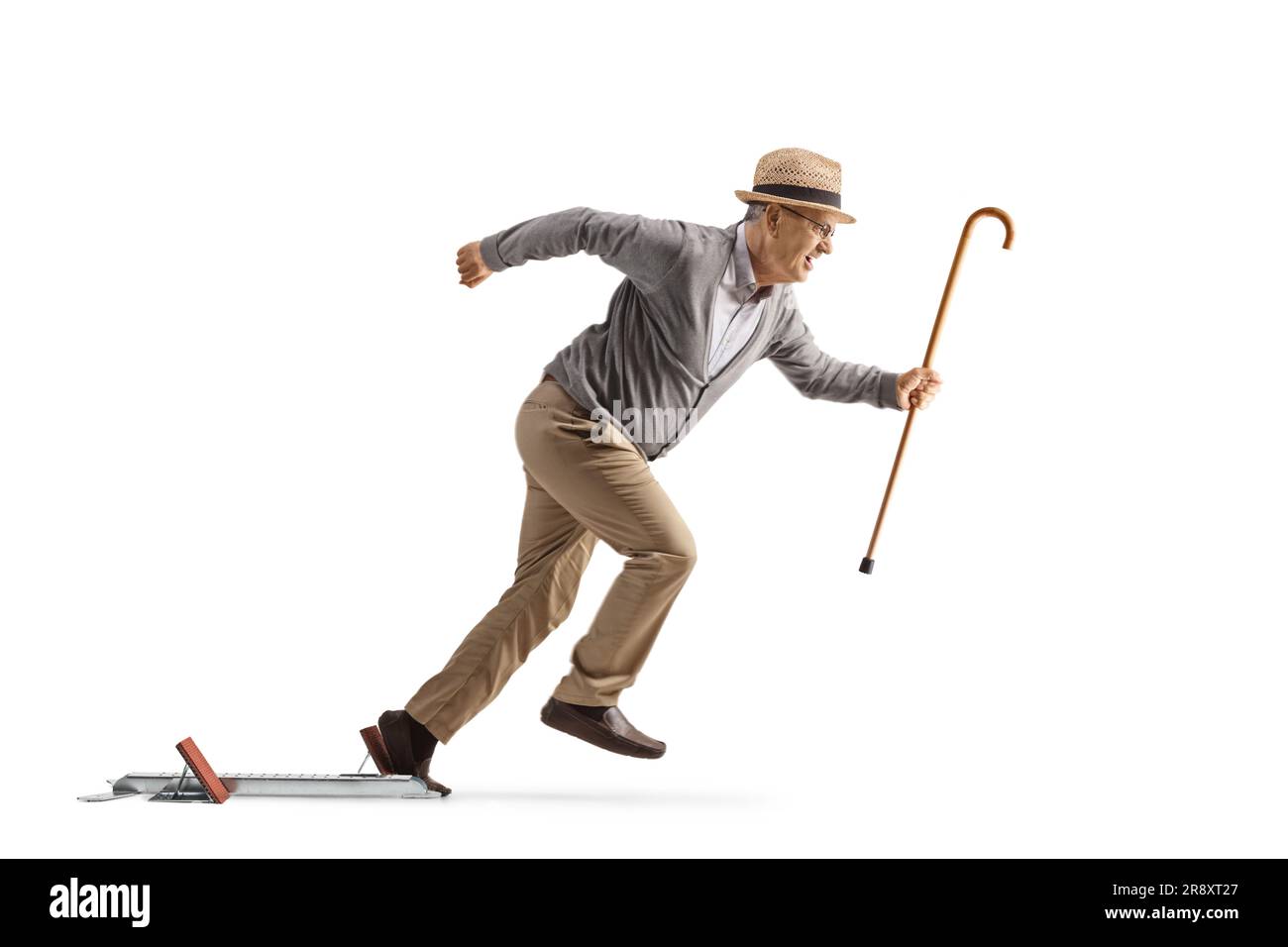 Senior man running a race from starting blocks isolated on white ...