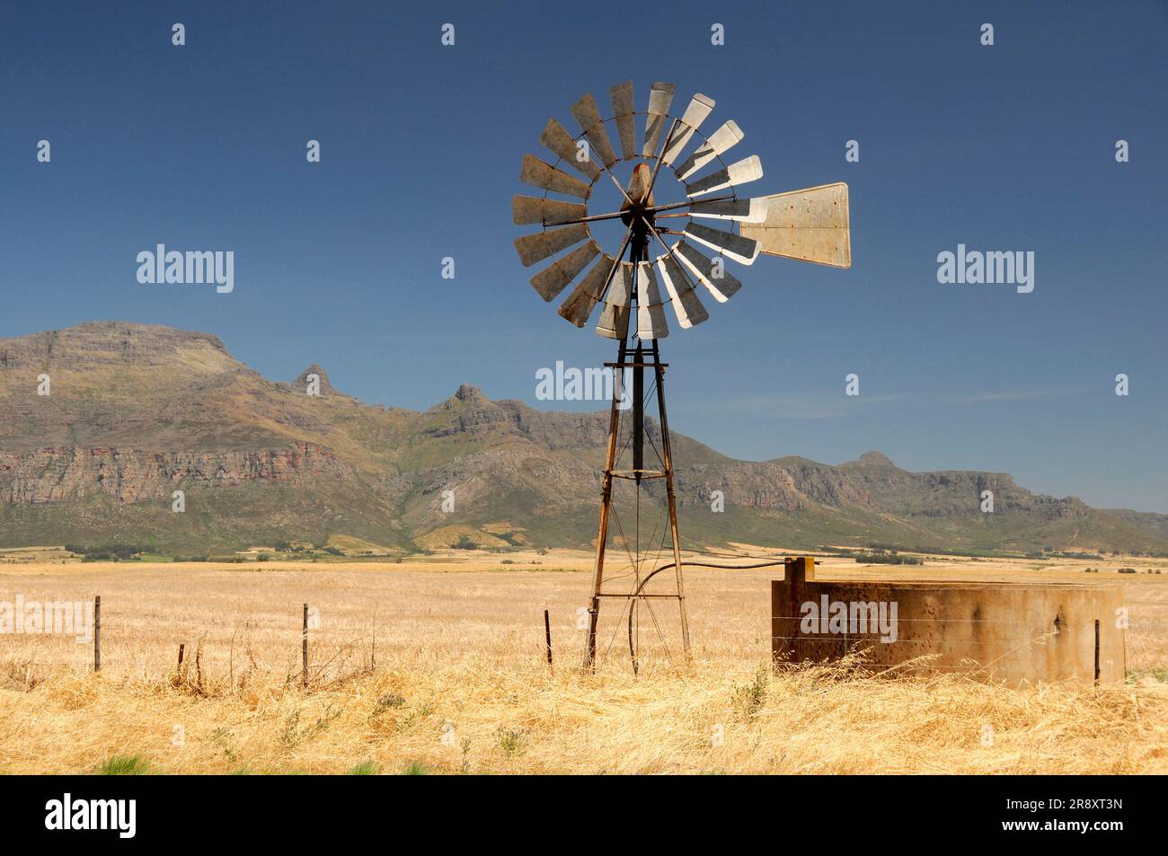 Wind wheel in fields with Mountain Range in the back near Piketberg ...