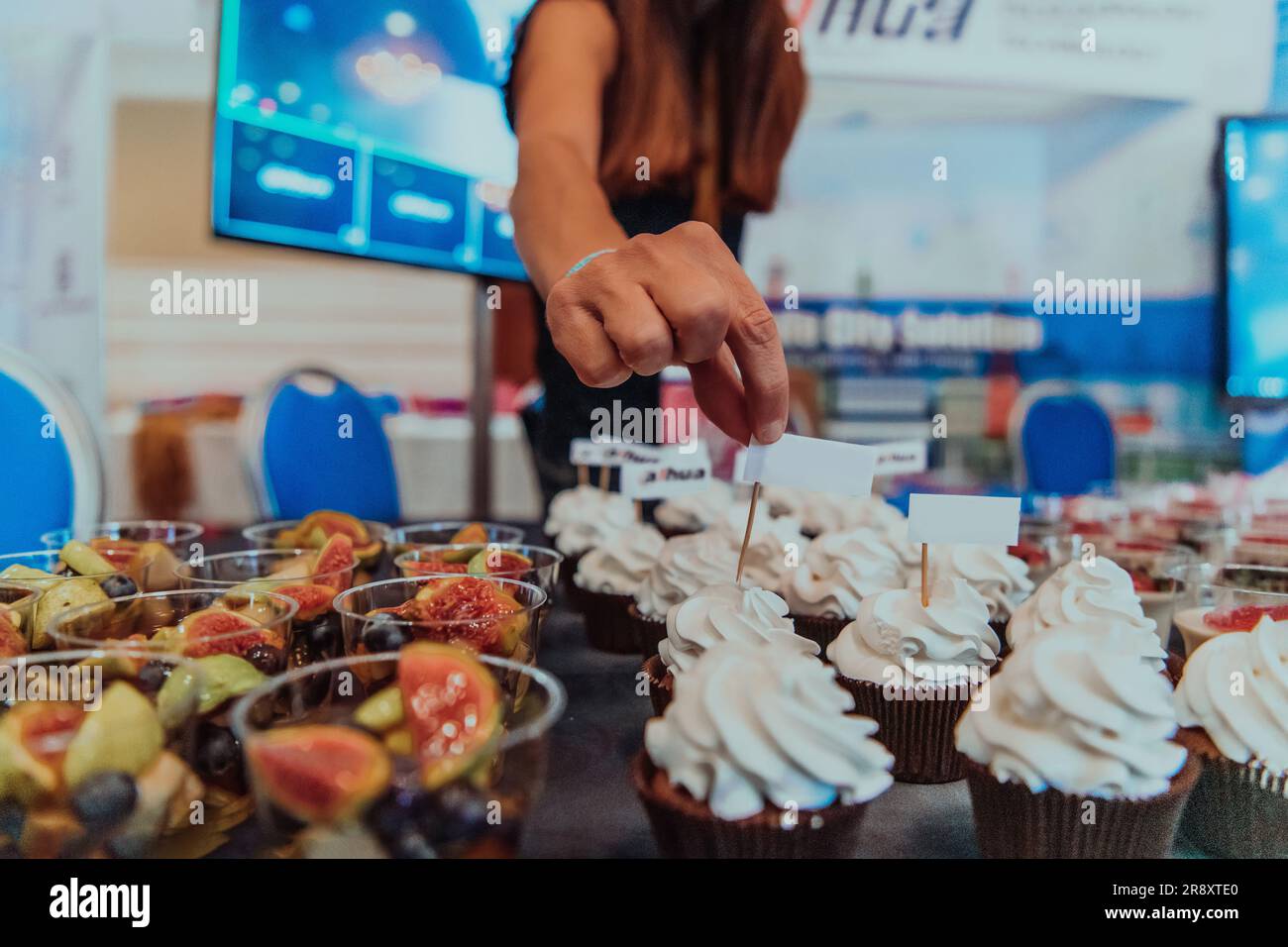 Business woman takes delicious food from the table while in the ...