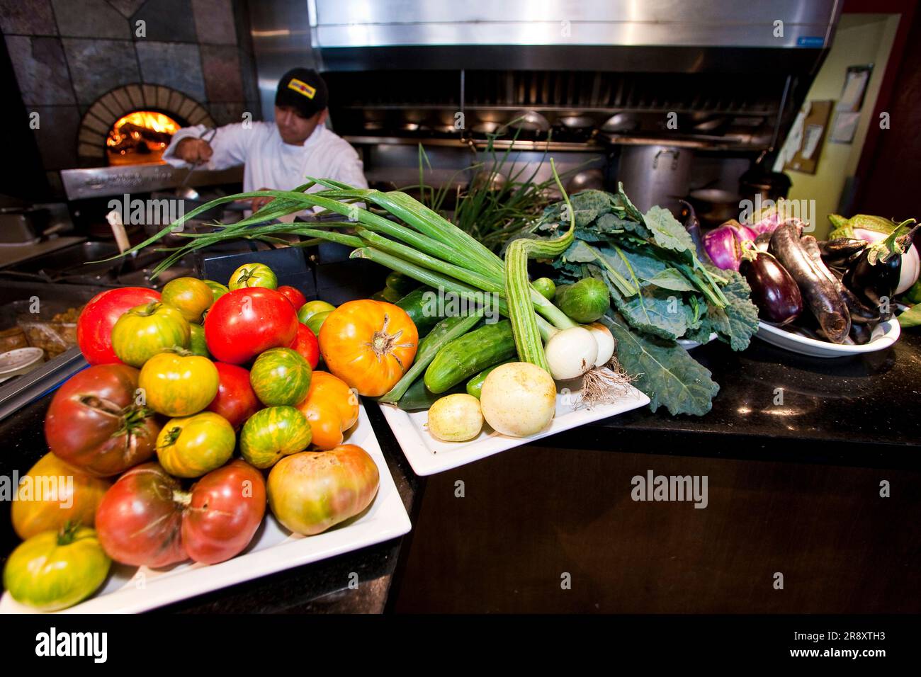 Restaurant staff preparing the evening's menu using organic produce ...