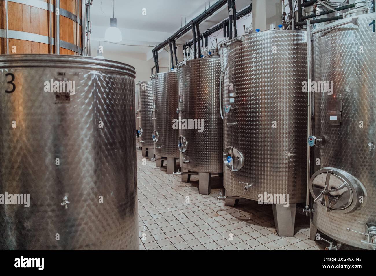Modern wine distillery and brewery with brew kettles pipes and ...