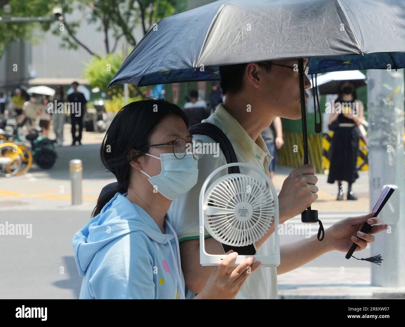 People walk in record-breaking heat wave in Beijing, China on June 23 ...