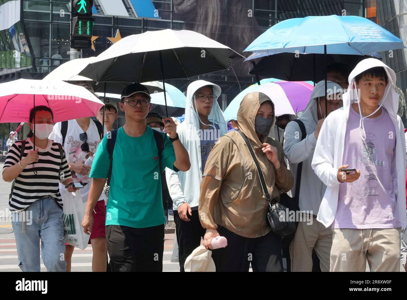 People walk in record-breaking heat wave in Beijing, China on June 23 ...