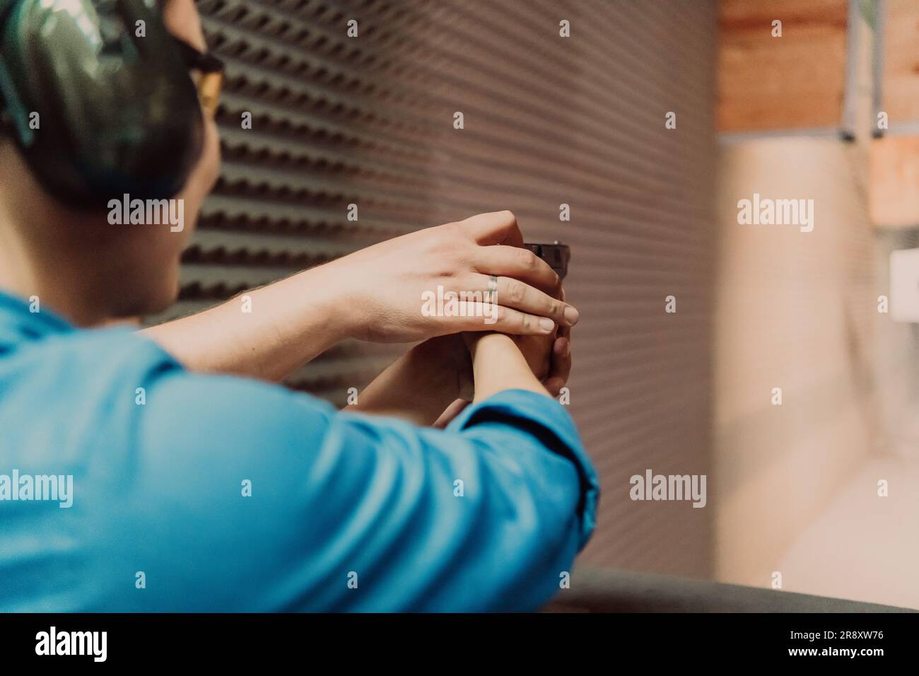 The trainer explaining to the man how to use the gun. Training in the ...