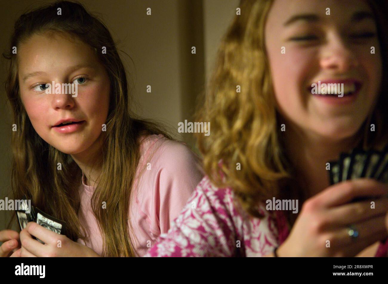 Two girls playing cards hi-res stock photography and images - Alamy