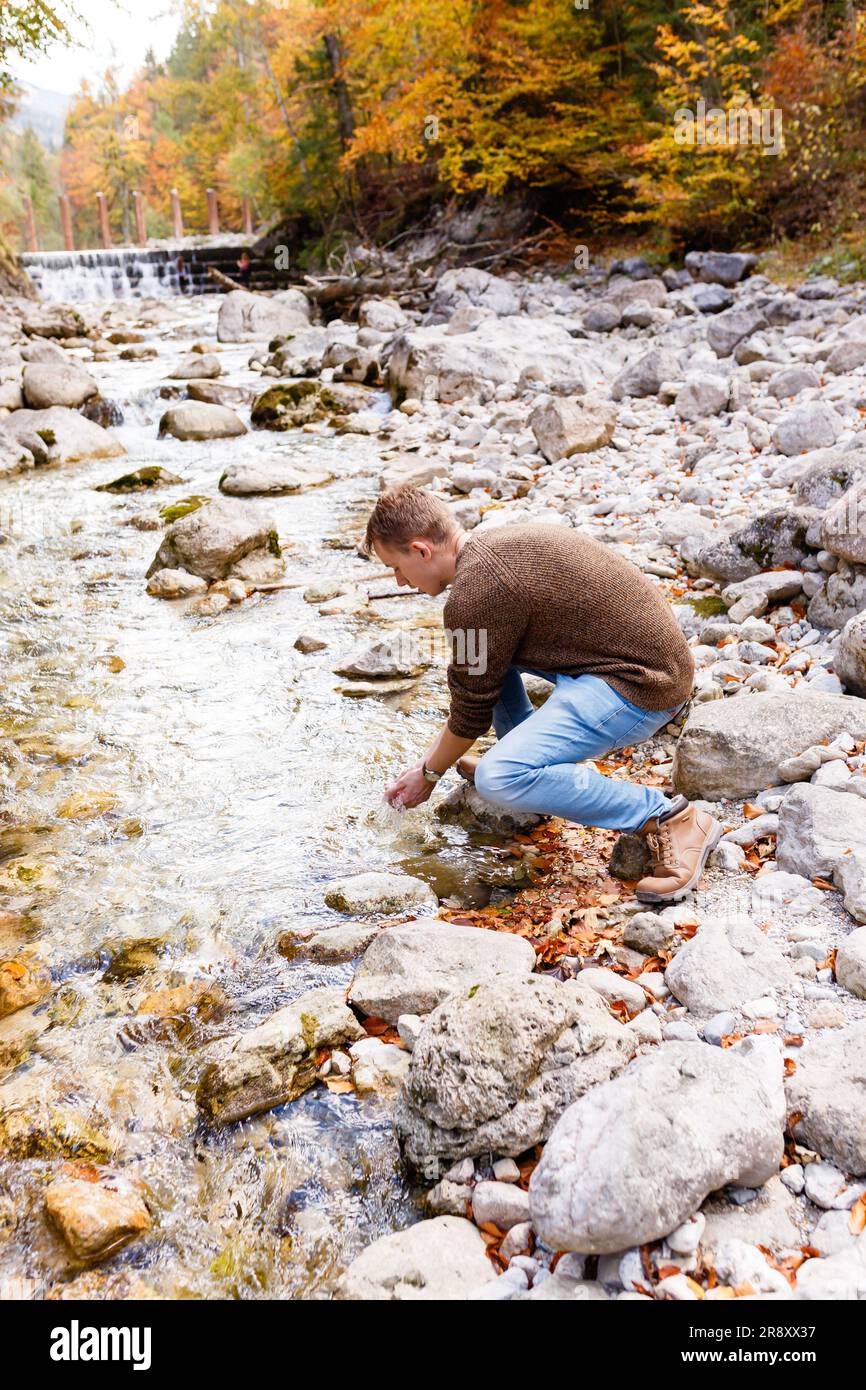 man near a mountain river in the forests of the Alps Stock Photo - Alamy