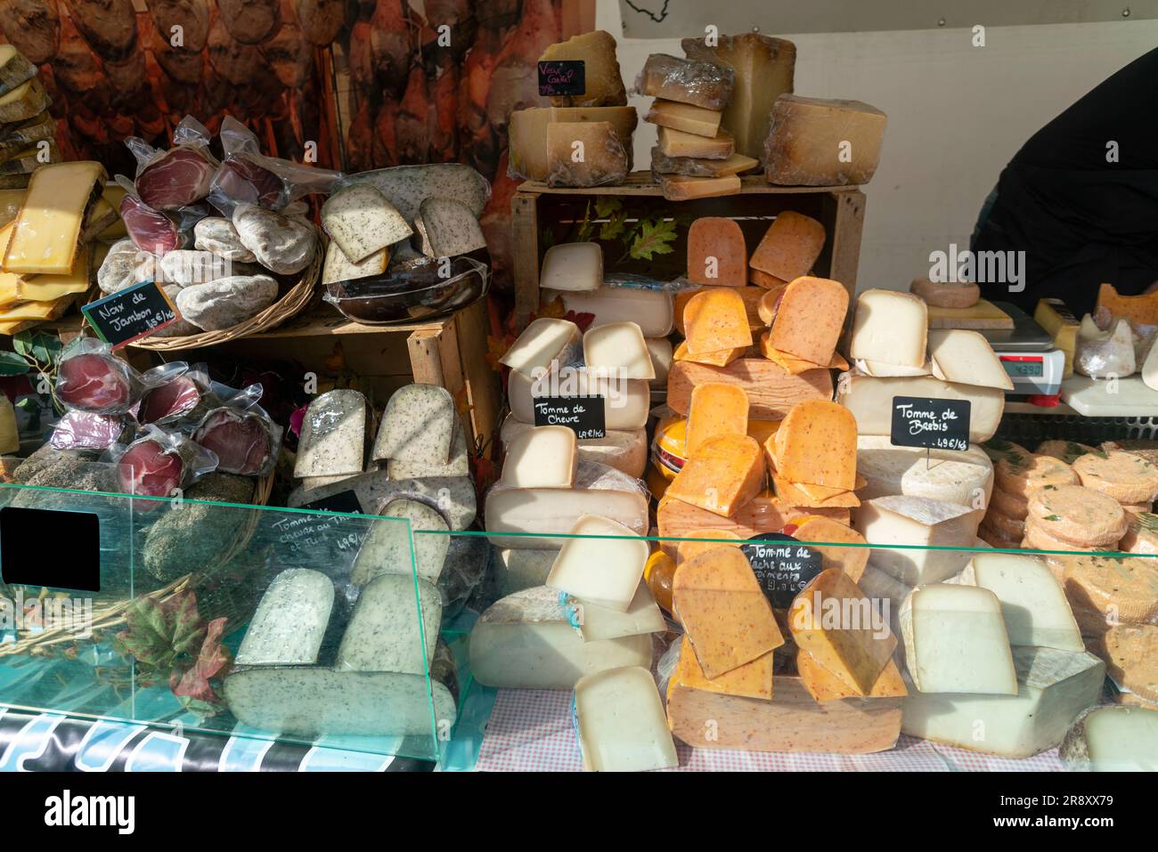Local cheese and pork offered at market in Montmartre, Paris, France ...