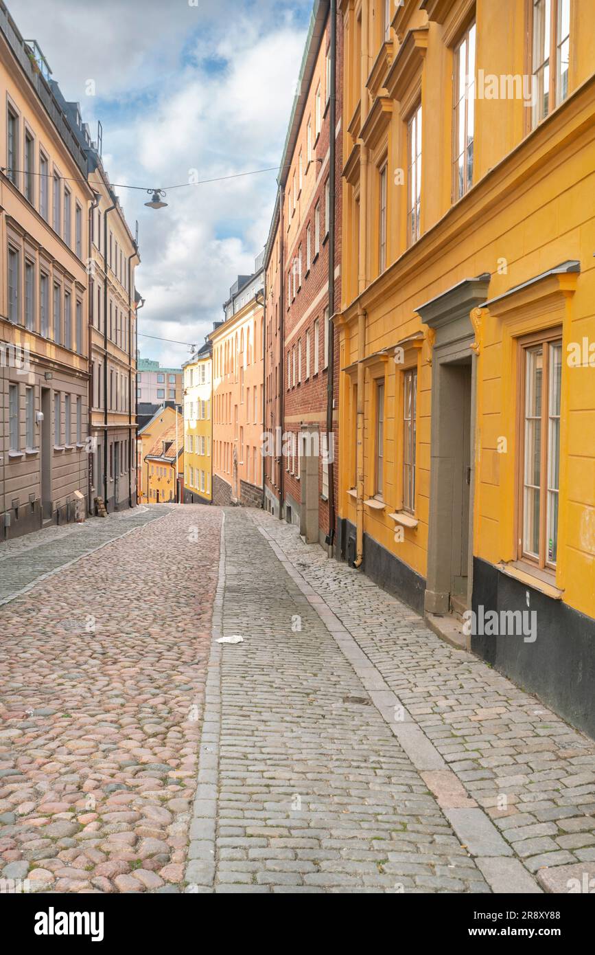 Narrow alley in the old town with yellow buildings, Stockholm, Sweden ...