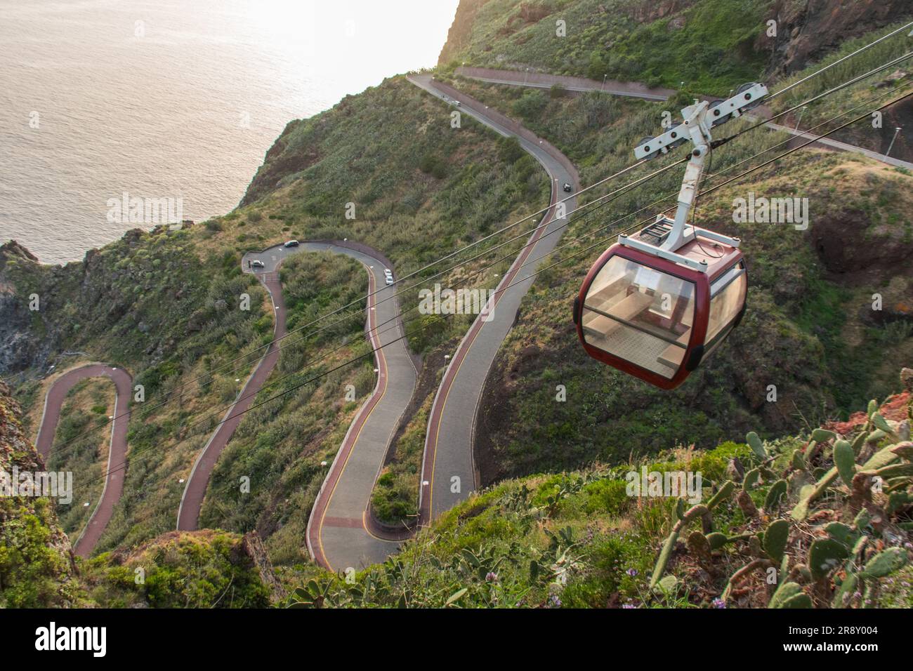 Cable car going down the slope towards the sea Stock Photo - Alamy