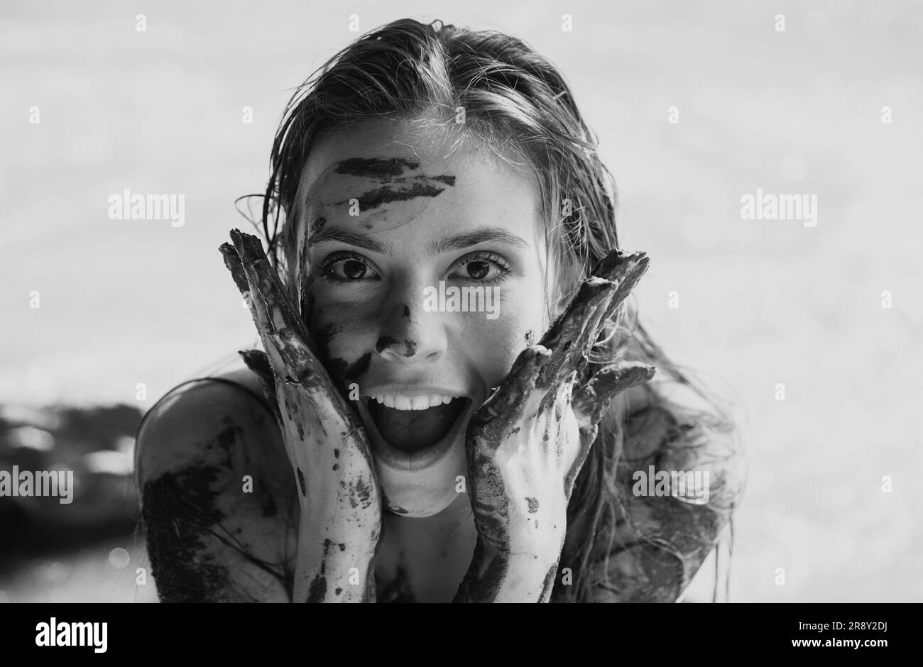 Dirty female model. Woman in clay mask laughs. Crazy girl in medical ...