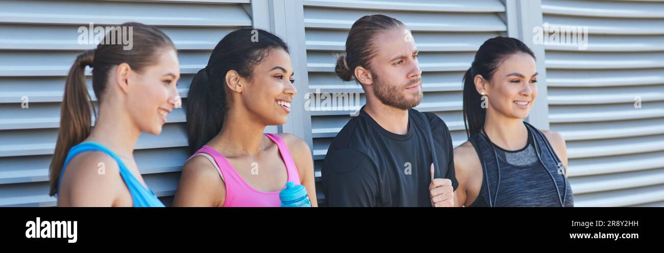 Young mixed race sportive people holding fitness equipment Stock Photo ...