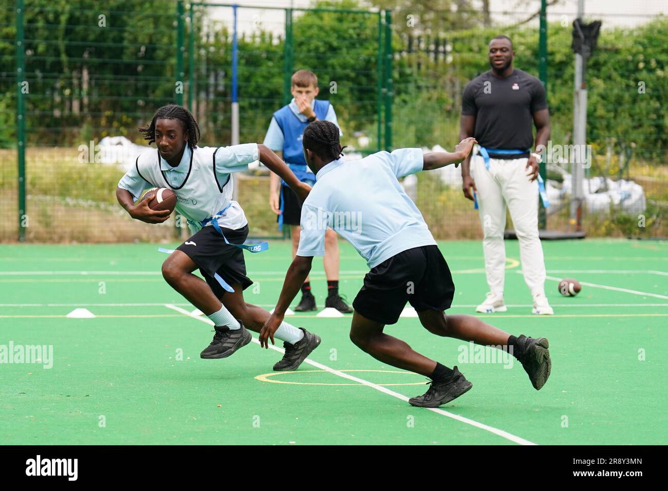 Students play American Football as Efe Obada from the NFL team ...