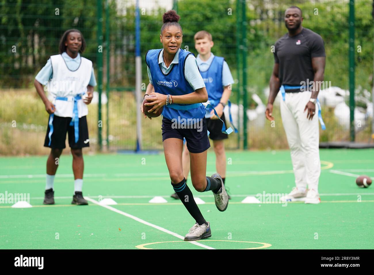 Students play American Football as Efe Obada from the NFL team ...