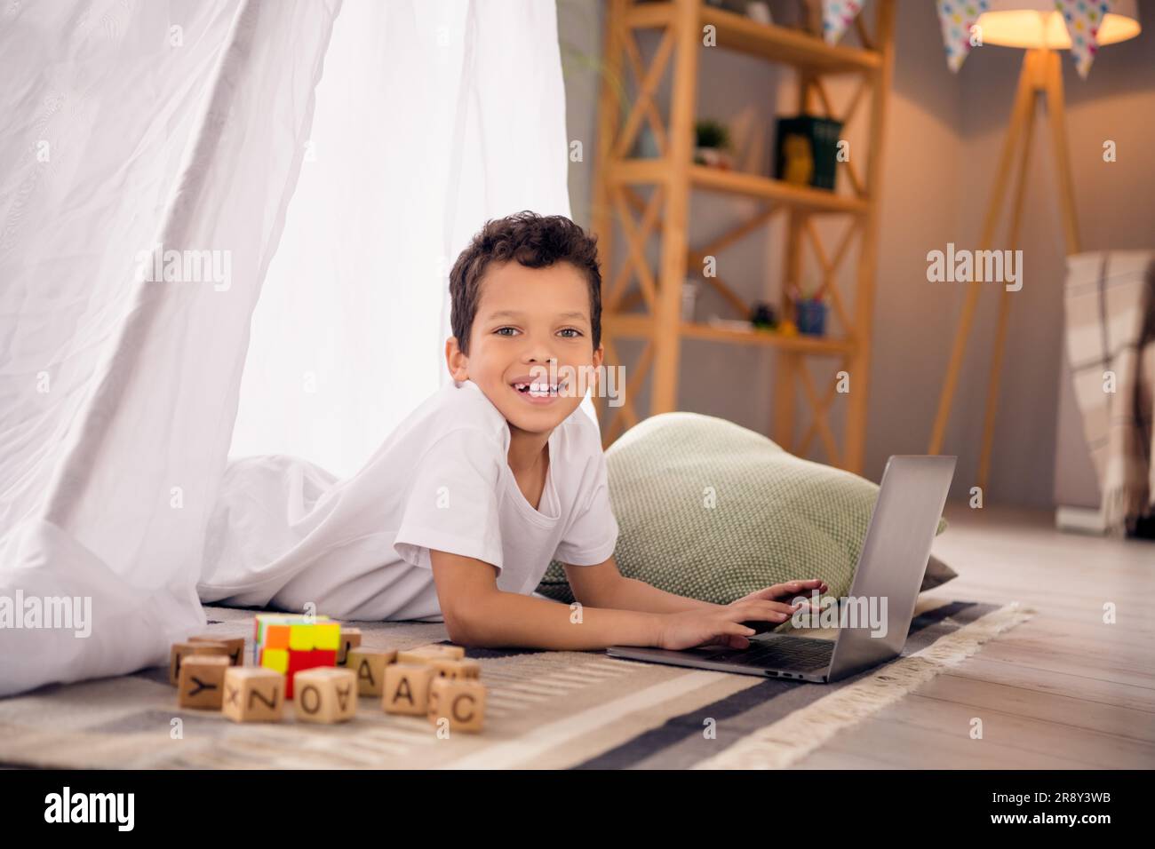 Photo of positive smart kid boy have homeschool use netbook device ...