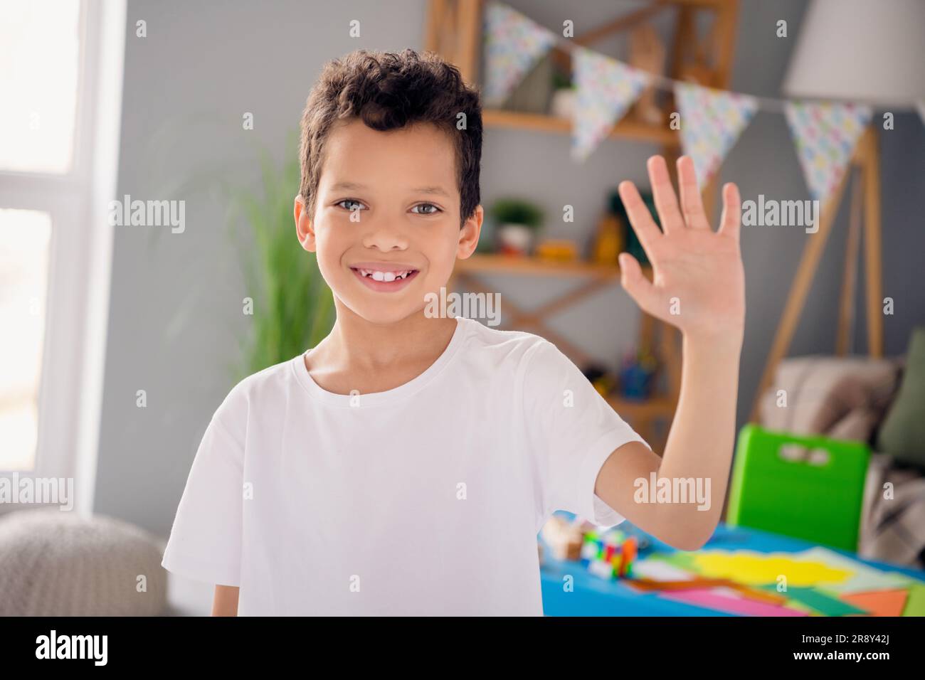 Photo of friendly excited little boy dressed white t-shirt smiling ...