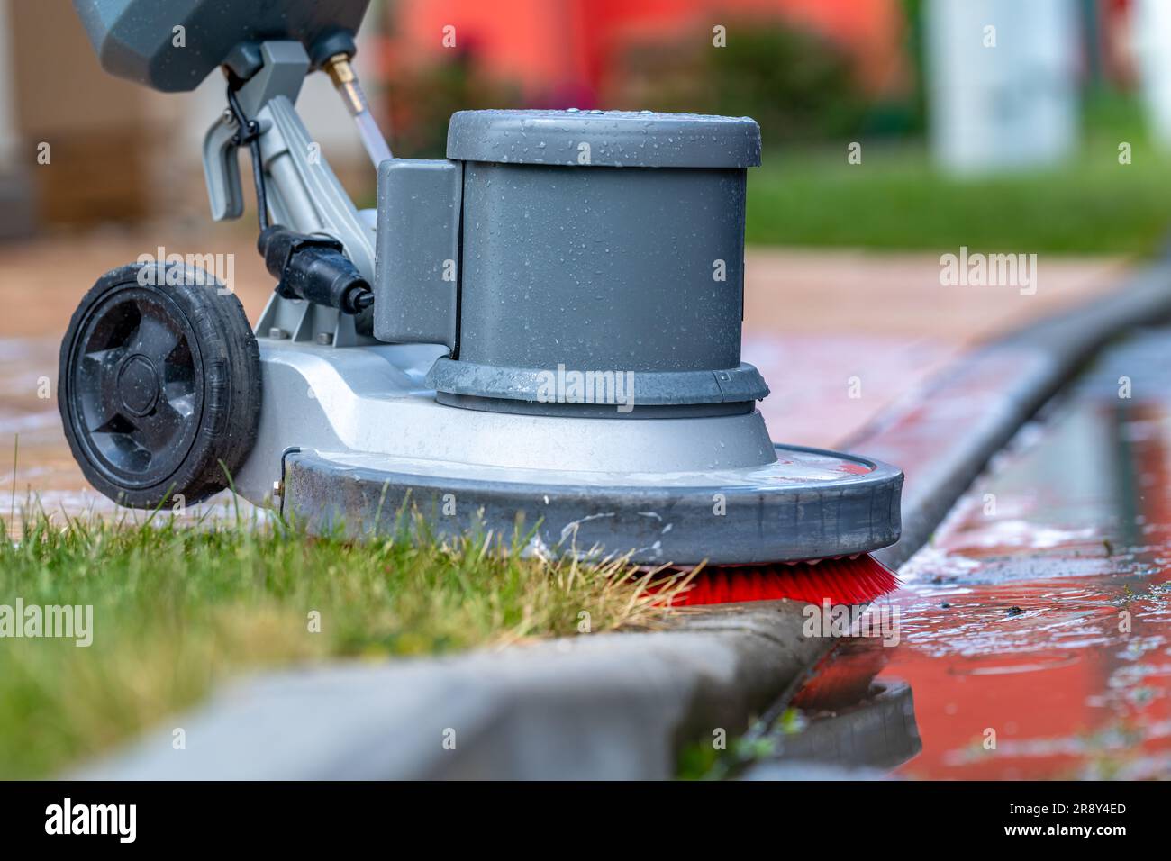 manual cleaning of concrete and stone pavements with a mechanical brush ...