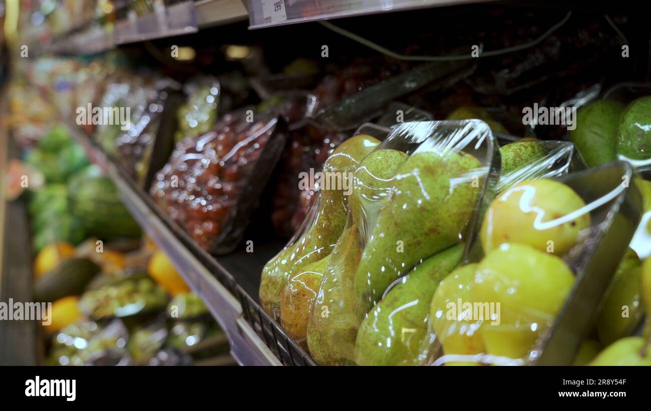 Vacuum-packed fresh fruit on the store shelf in the supermarket Stock ...