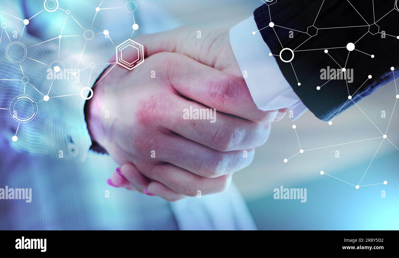 Handshake between business people; light effect Stock Photo - Alamy