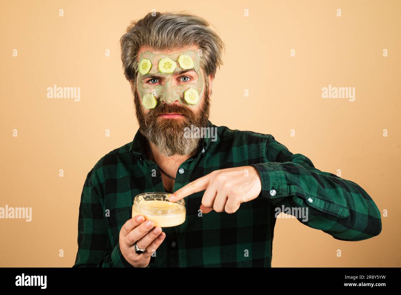 Spa man applying facial clay mask. Funny man with facial masks having ...