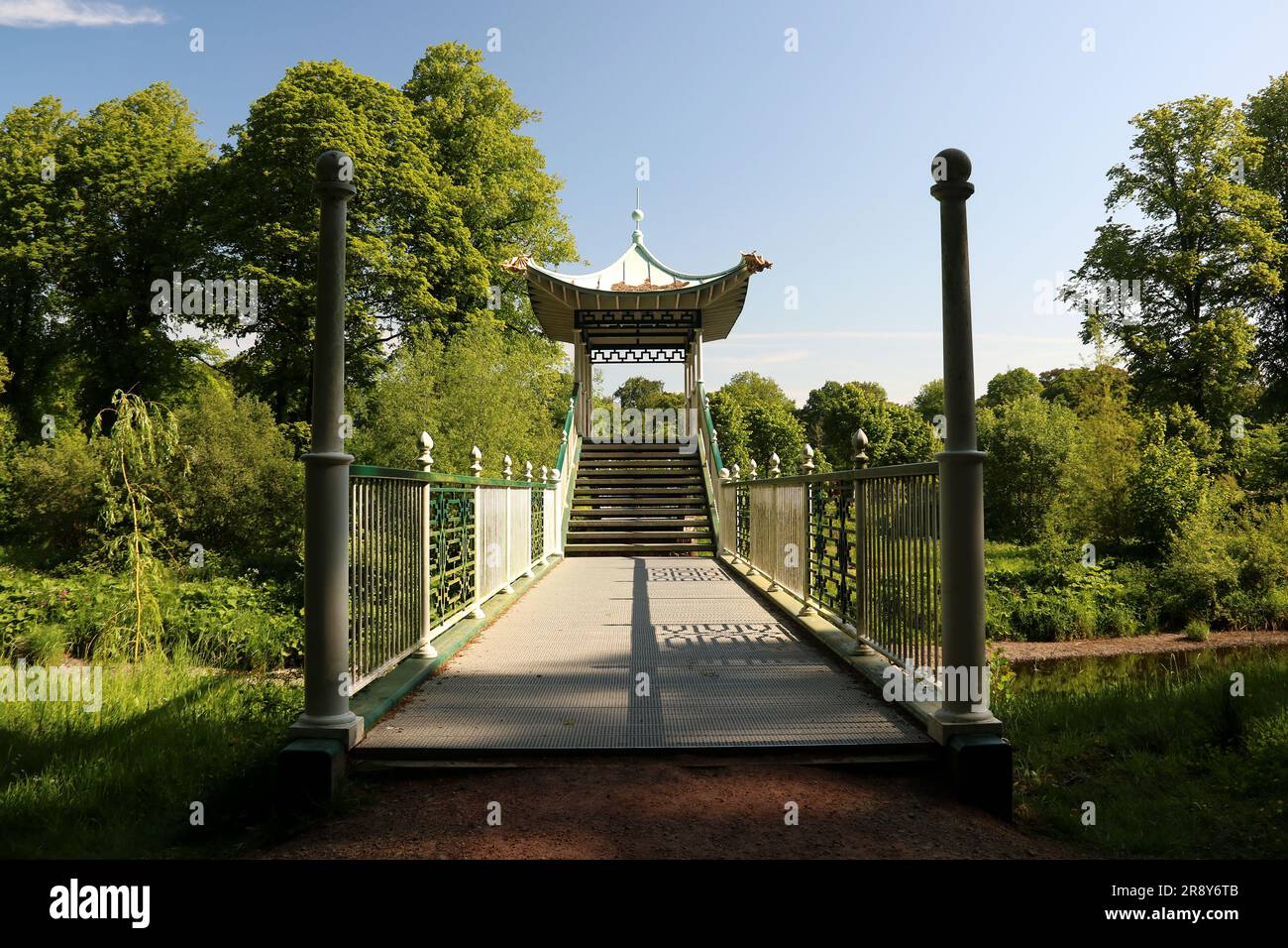 Chinese bridge spanning over a river in a country estate park Stock ...