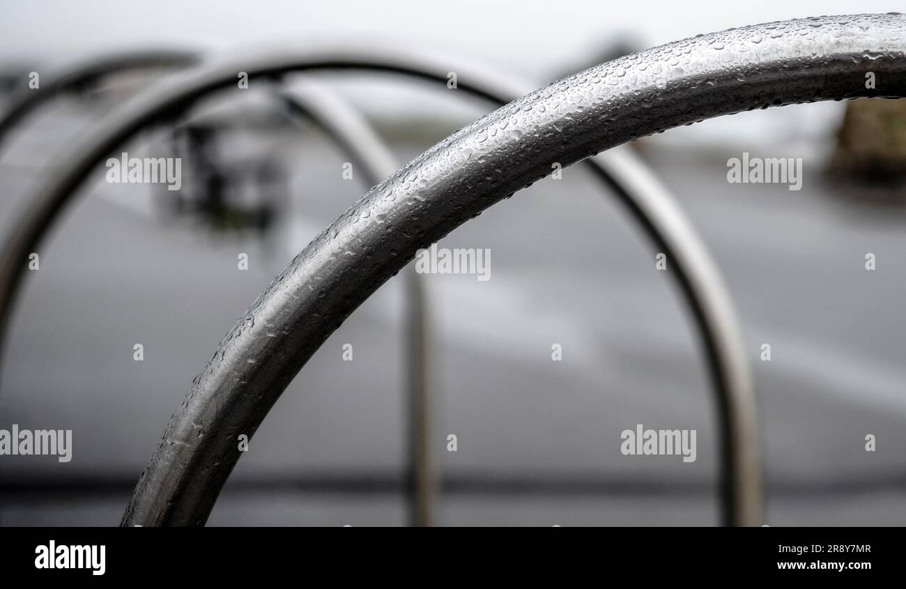 A grayscale of an urban street scene featuring raindrops on bicycle ...
