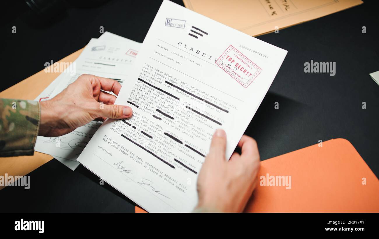 Military man reads Secret Documents Stock Photo - Alamy