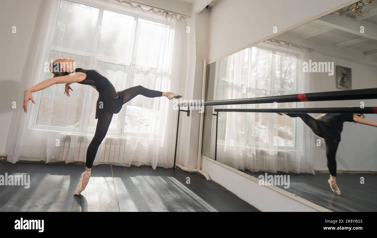 A beautiful Asian woman is dancing at the barre. Ballet dancer Stock ...