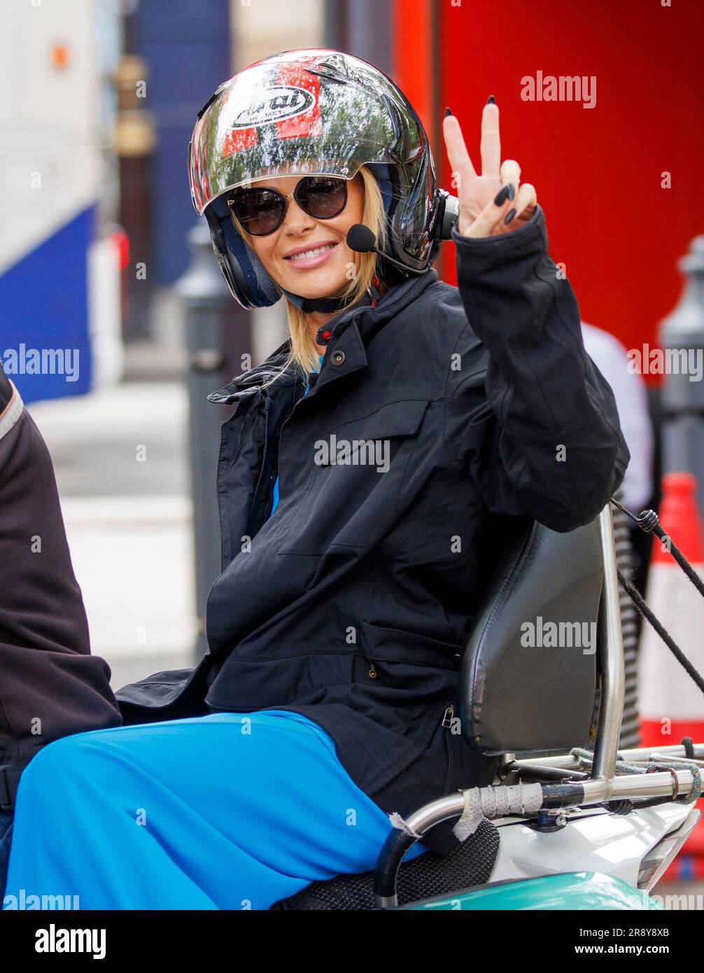 London, UK. 23rd June, 2023. Amanda Holden gets onto a Taxi Bike after ...