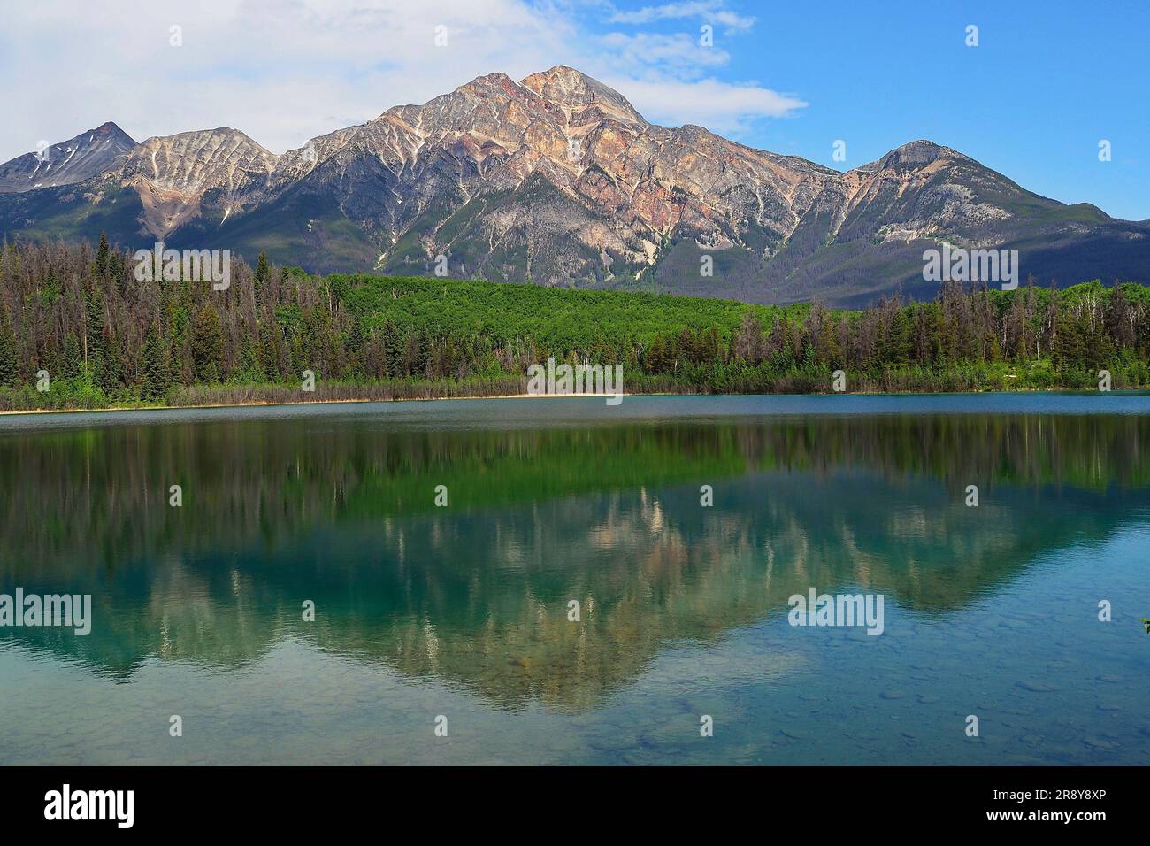 Pyramid mountain and its reflection on the lake in the Rocky Mountains ...