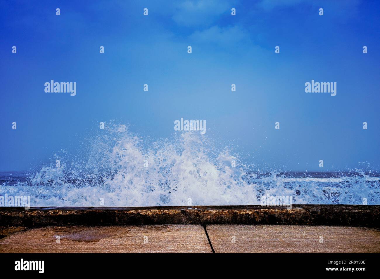 Wave spray caught in mid action on a sea wall in Scarborough Stock ...
