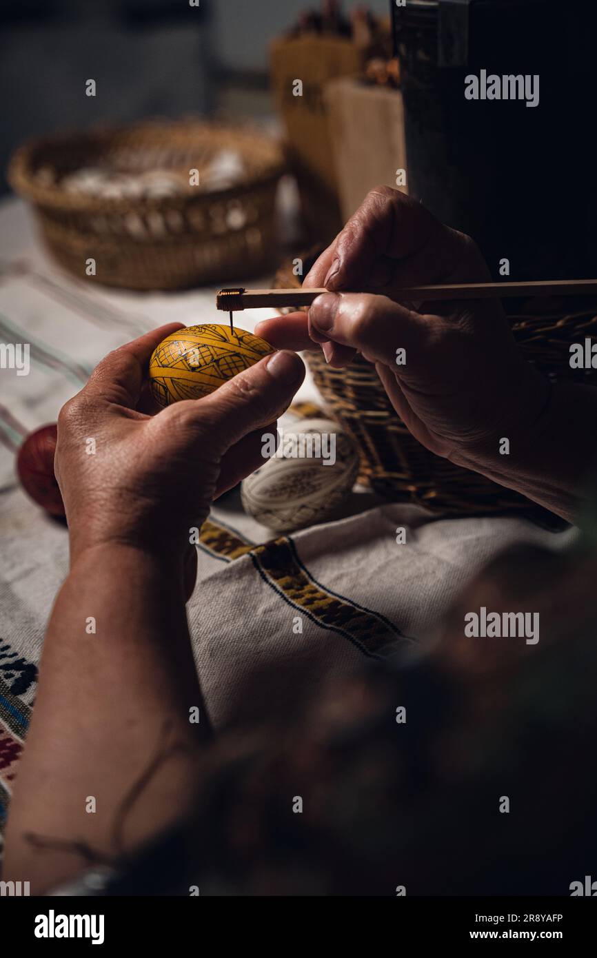 A basket filled with colorful, hand-painted Easter eggs, made using ...