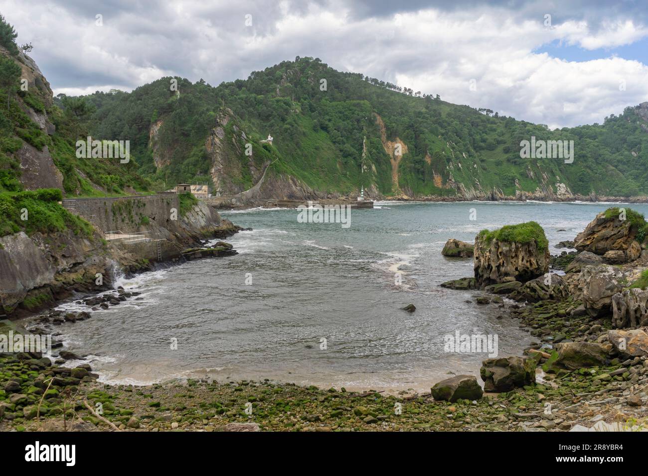 Small sandy and rocky beach located near the coastal and fishing ...