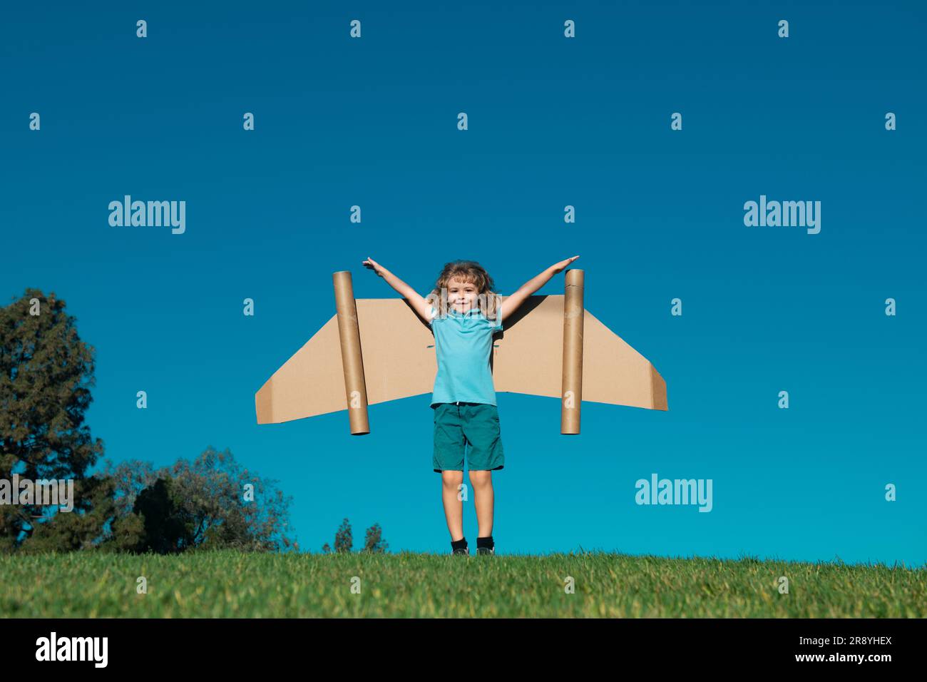 Boy child with wings at sky imagines a pilot and dreams of flying. Kids ...