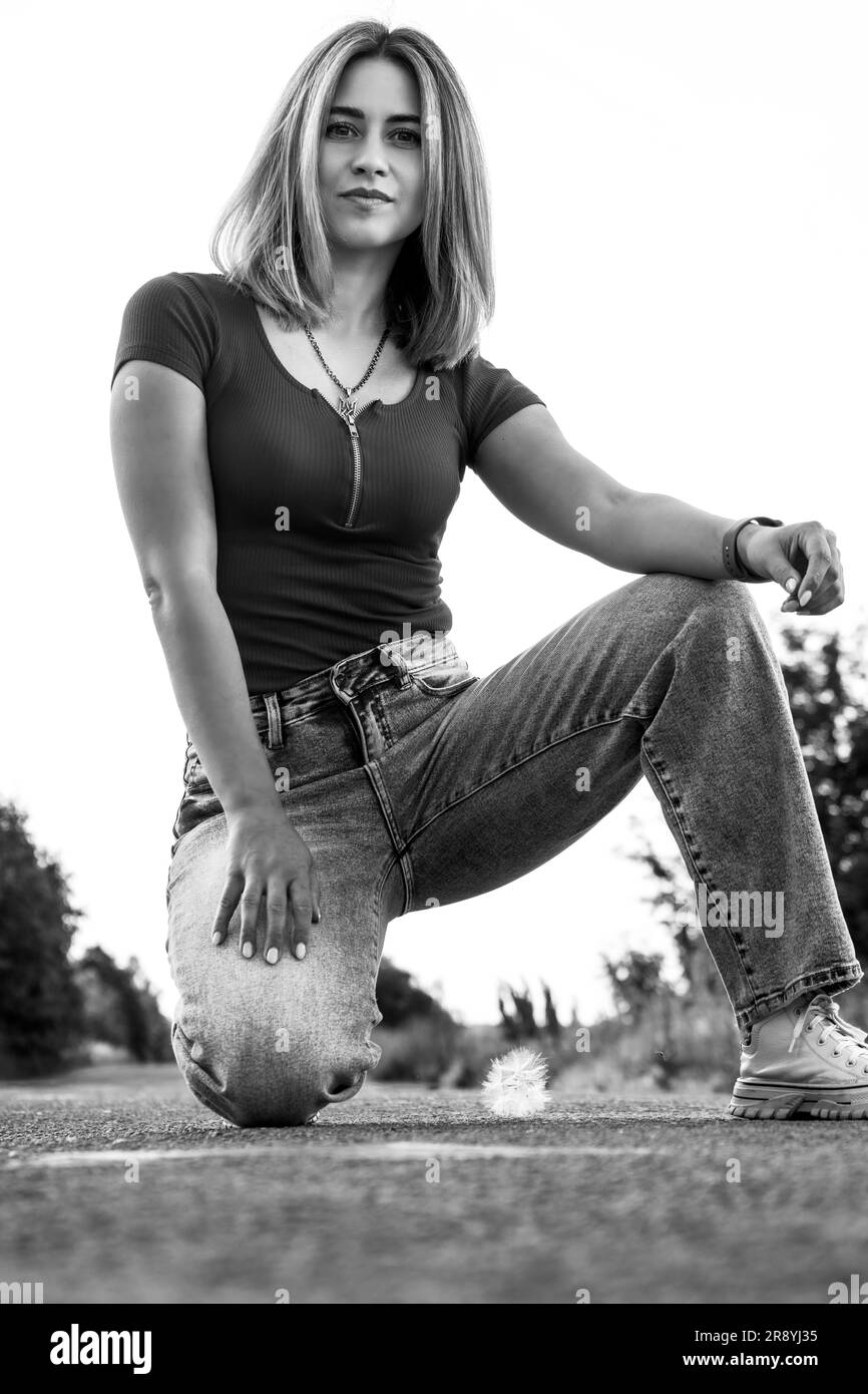 Blonde in jeans on the road Stock Photo - Alamy