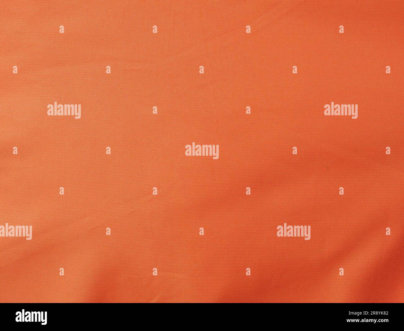 orange polyester fabric texture useful as a background Stock Photo - Alamy