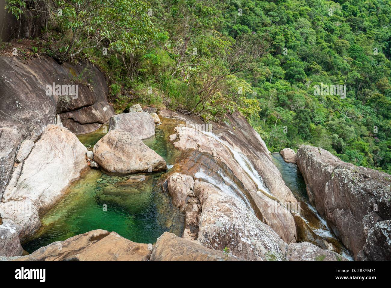 Beautiful green crystal clear water pool in the rock surrounded by ...