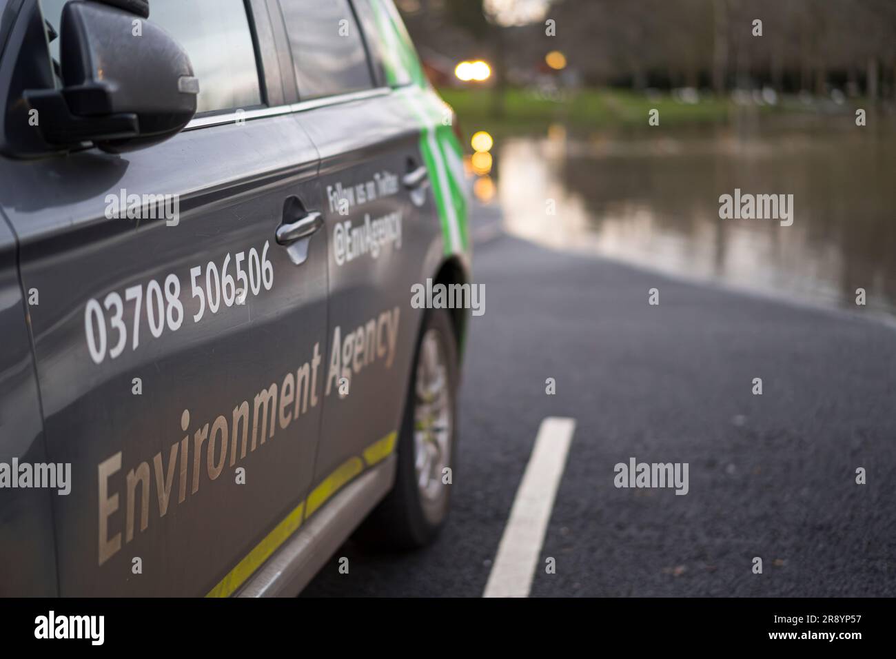 Side view of an isolated Environment Agency vehicle parked in a flooded ...