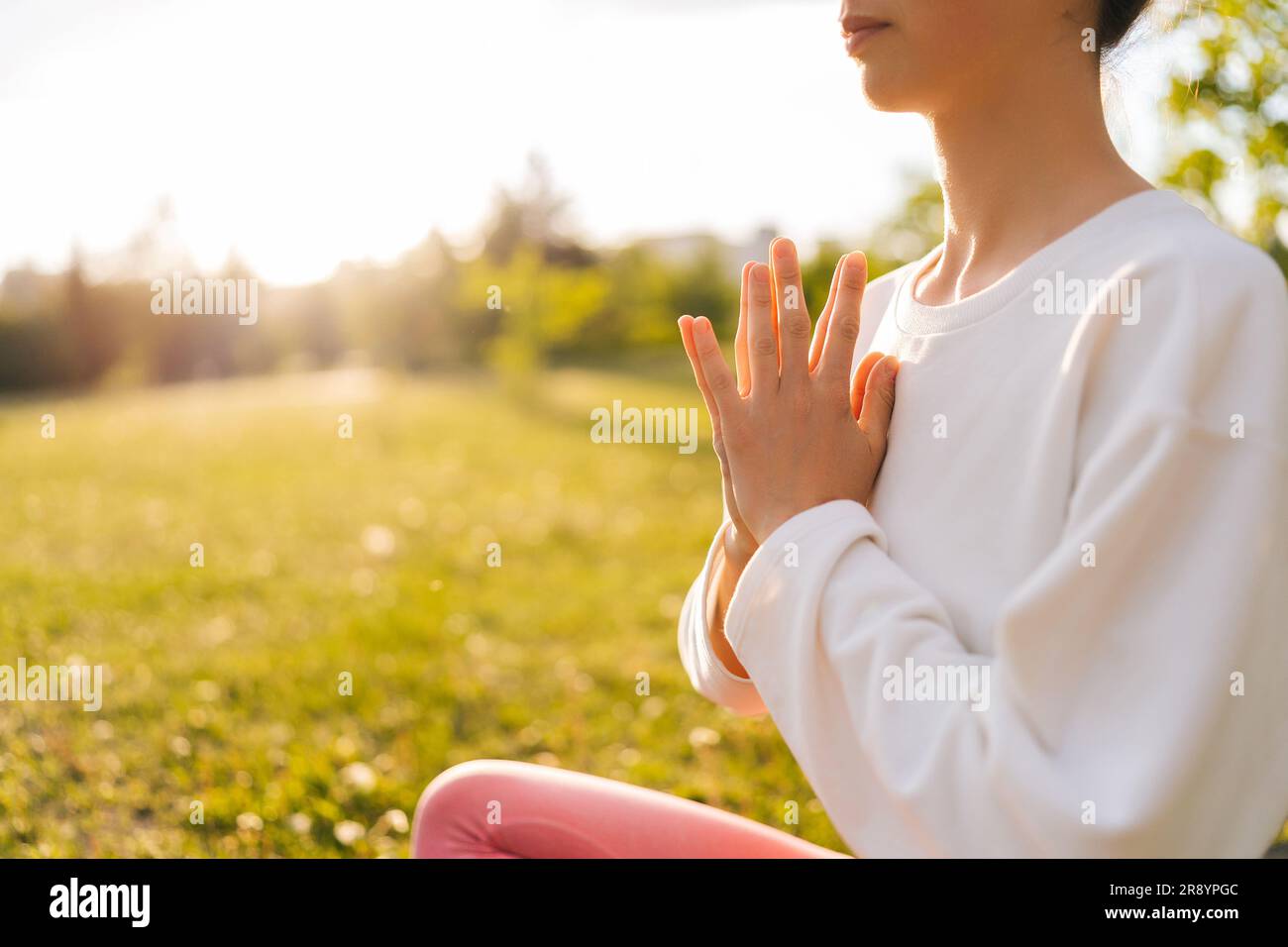 Close-up cropped shot of unrecognizable young woman practicing yoga ...