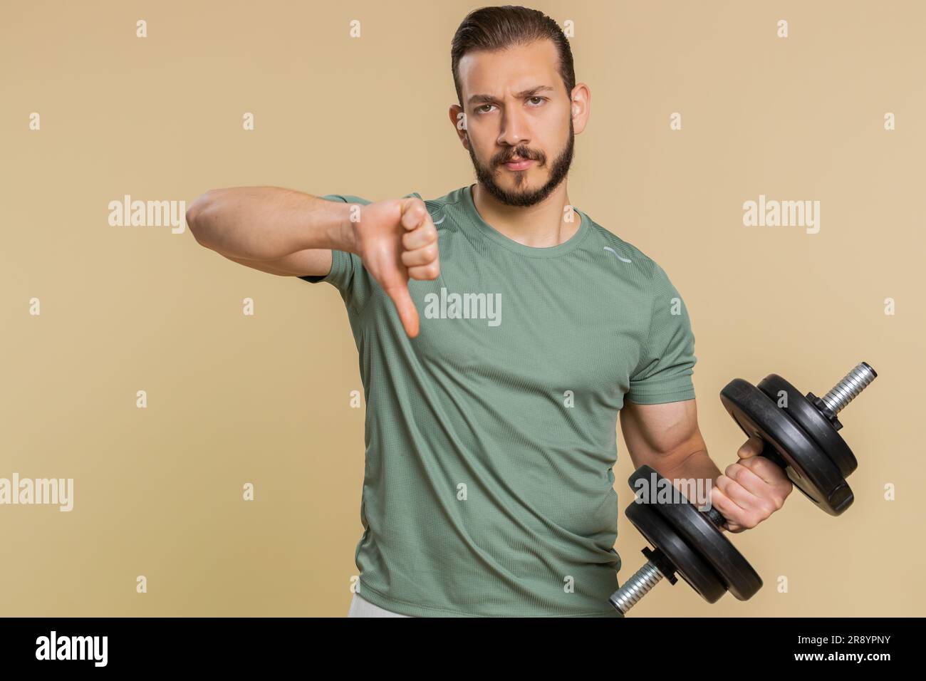 Upset tired athlete sportive man showing thumbs down sign gesture ...