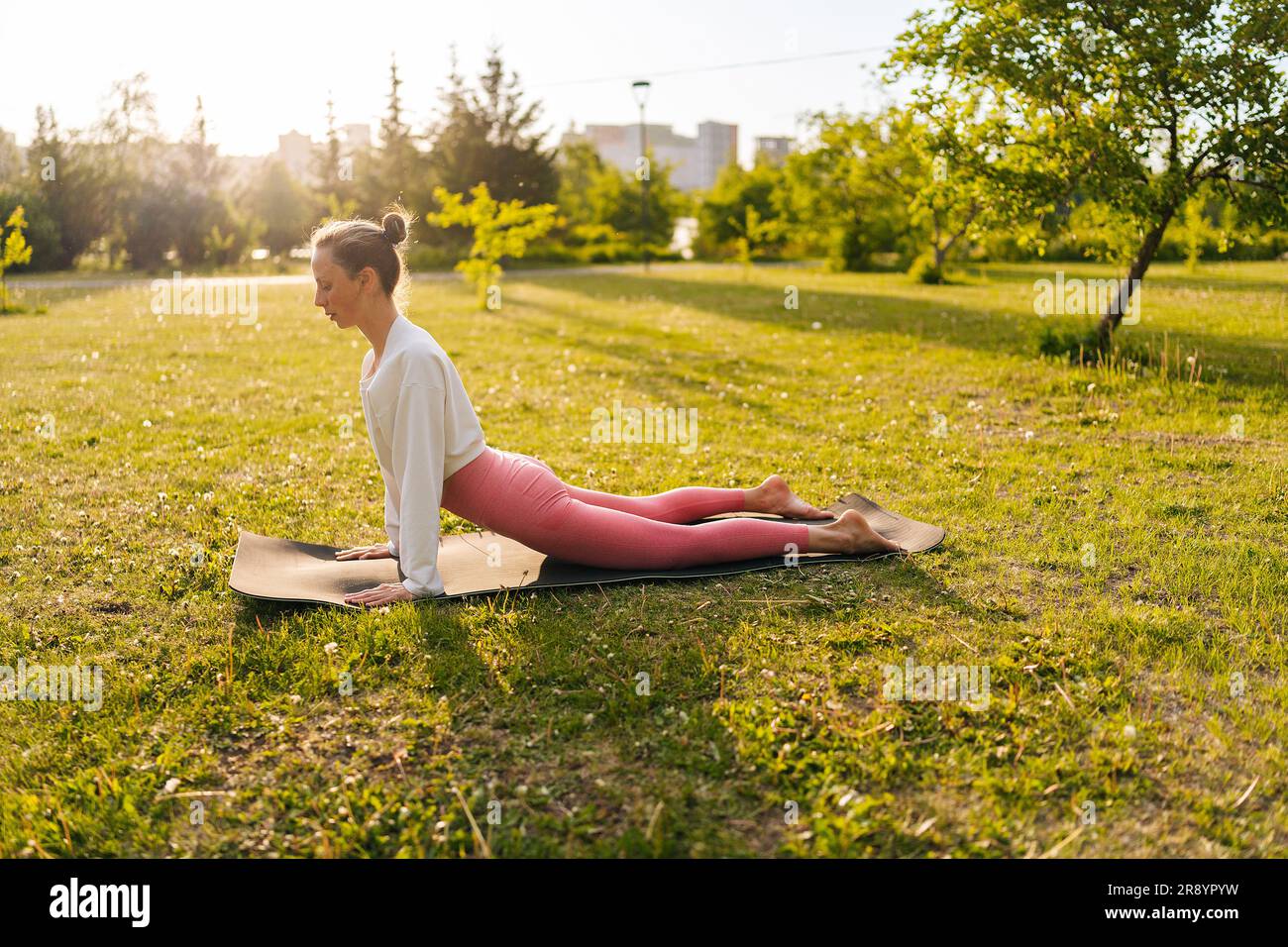 Side view of beautiful fit young woman in sportswear working out ...