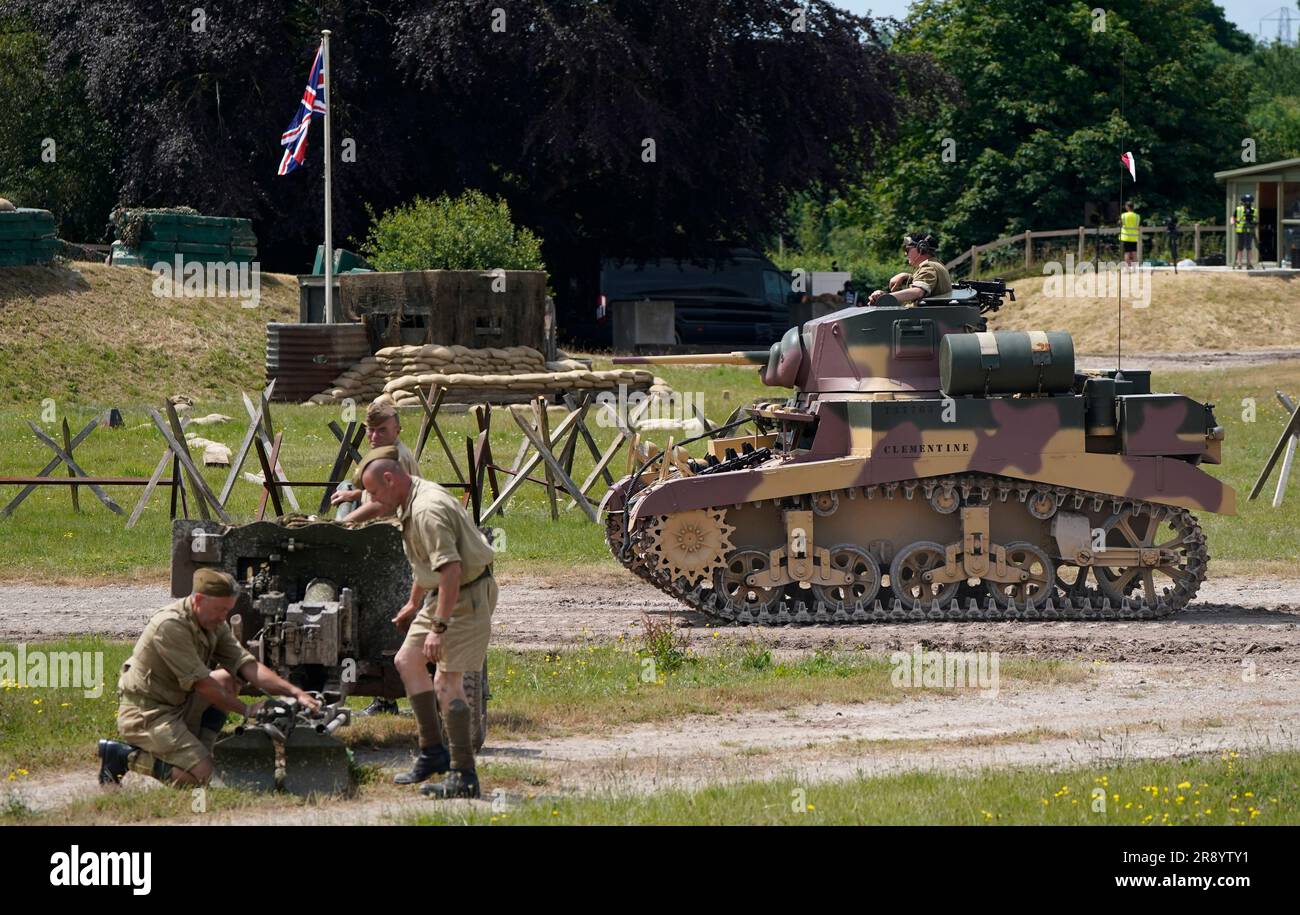 A Stuart M3A1 tank (right) is driven around the Kuwait Arena during day ...