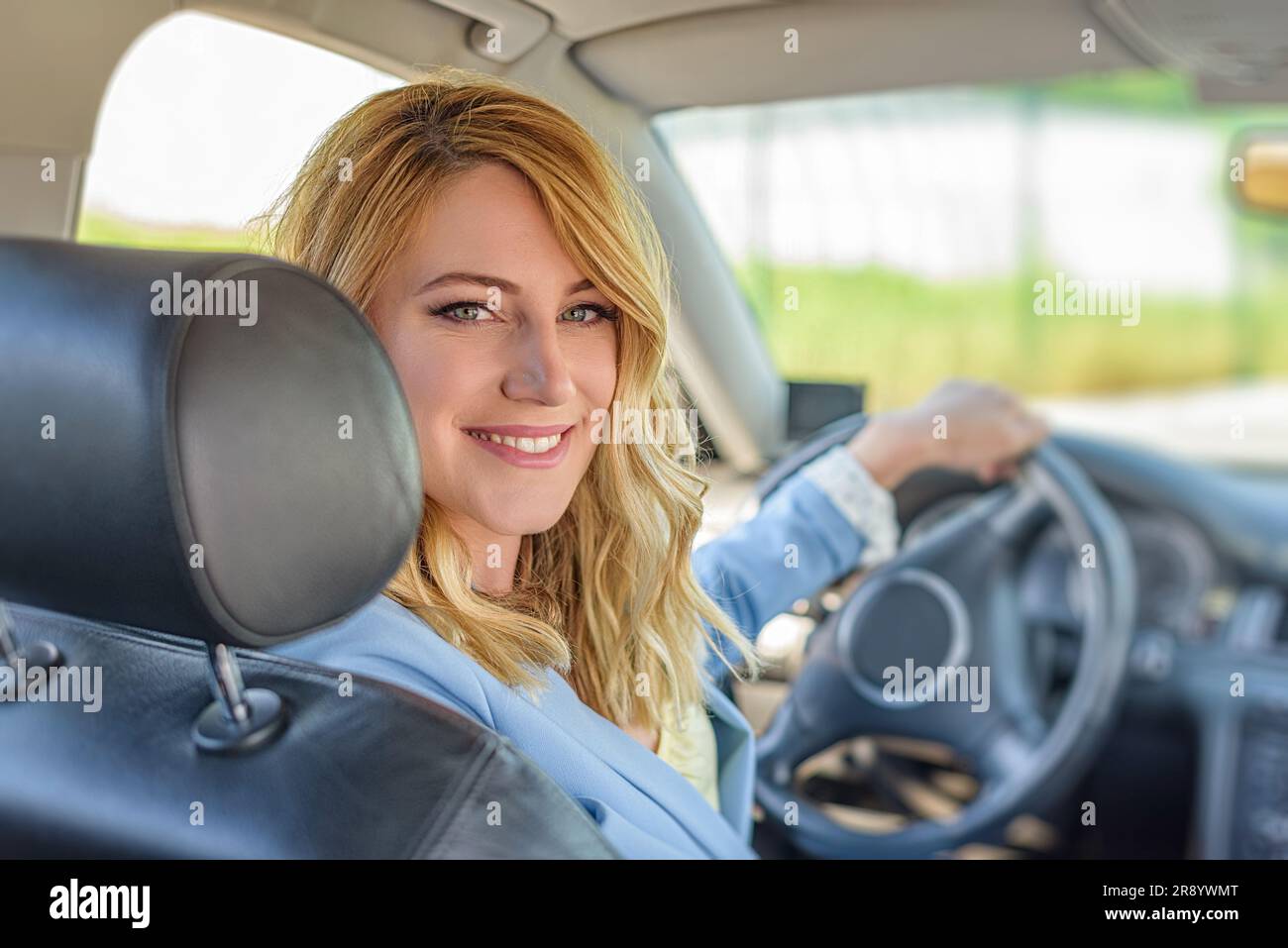 Attractive female driver in the car Stock Photo - Alamy