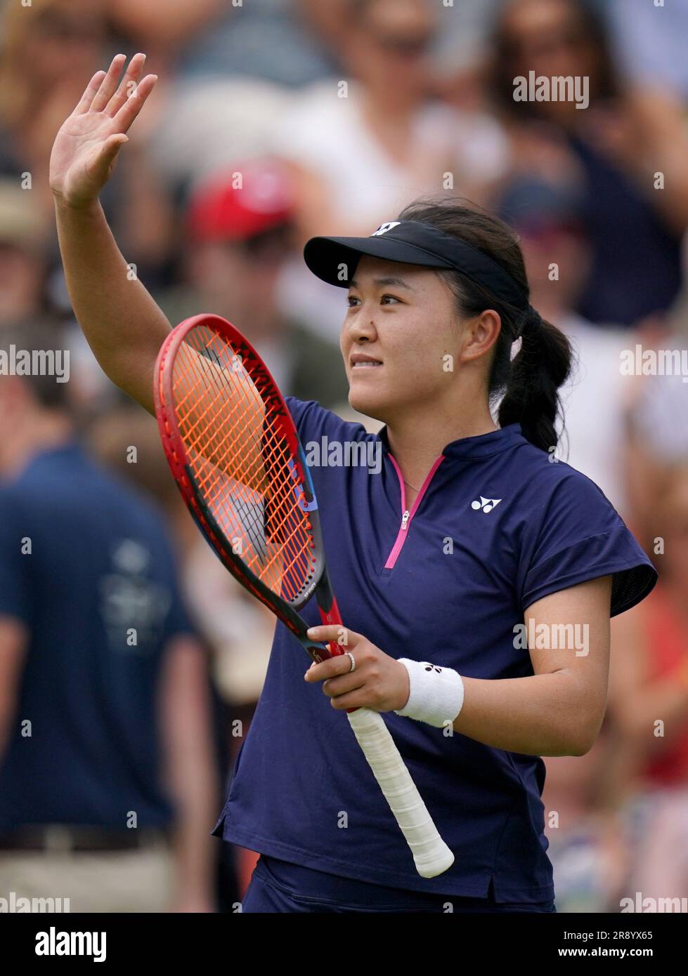 Lin Zhu waves to the crowd after winning her match against Rebecca ...